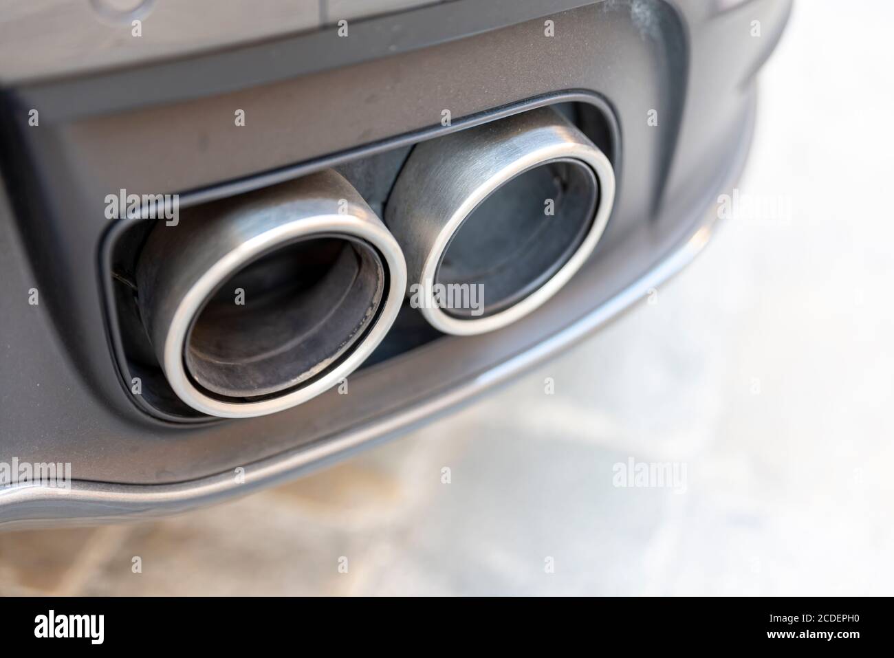 a cylindrical double sports car exhaust Stock Photo - Alamy