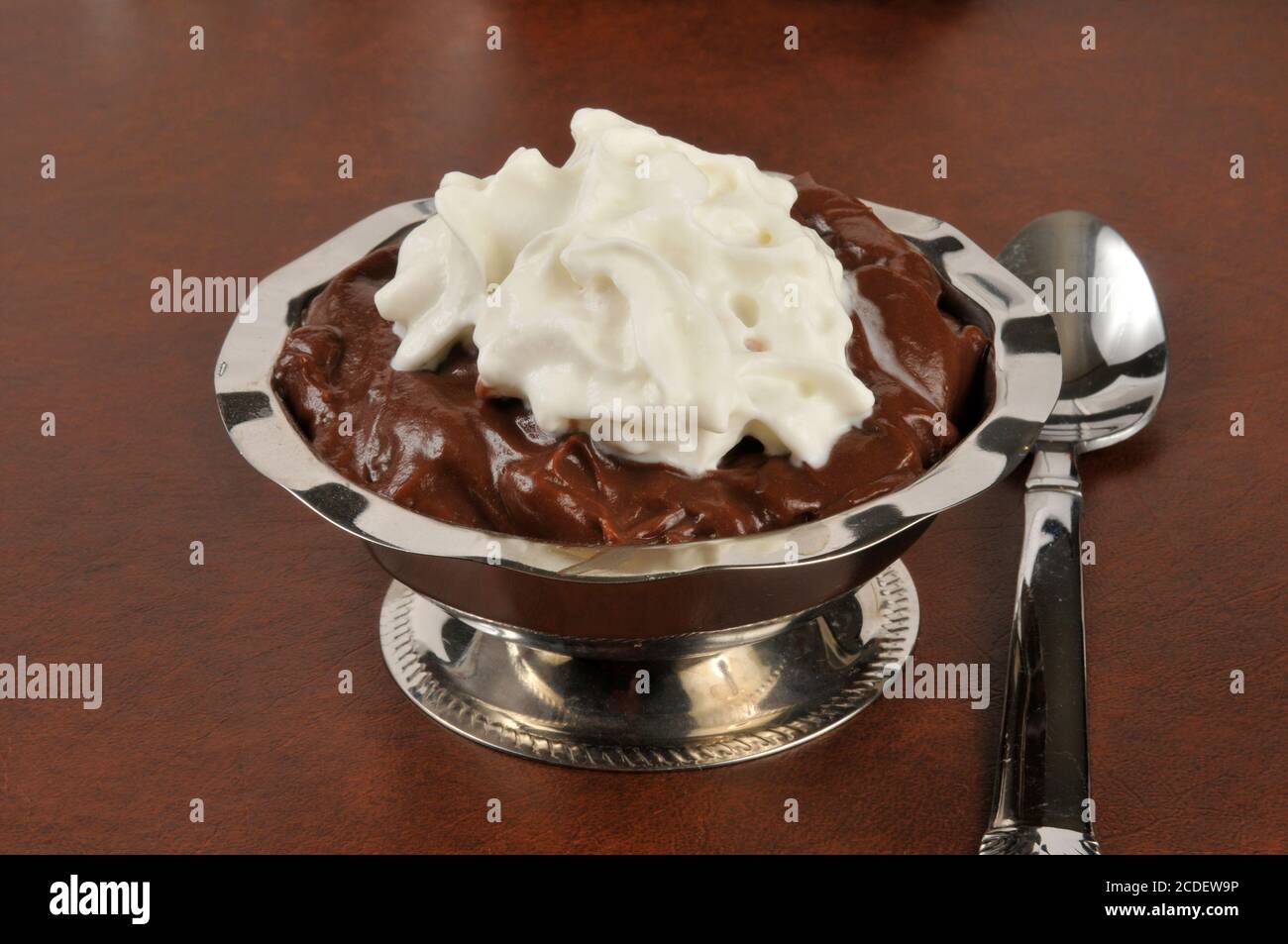 A silver dish of chocolate pudding with whipped cream Stock Photo - Alamy