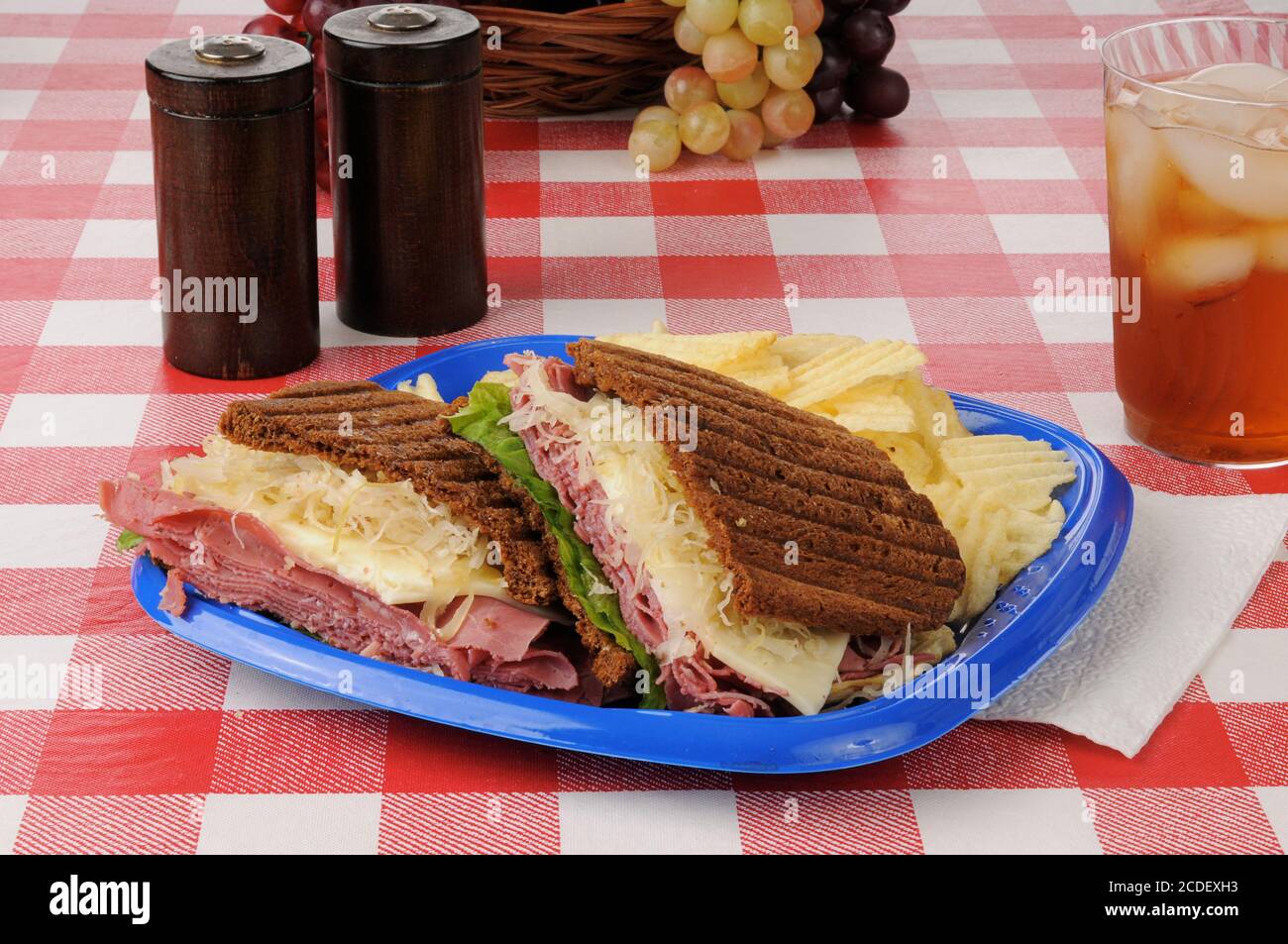 A ruben sandwich on a picnic plate with cola Stock Photo - Alamy