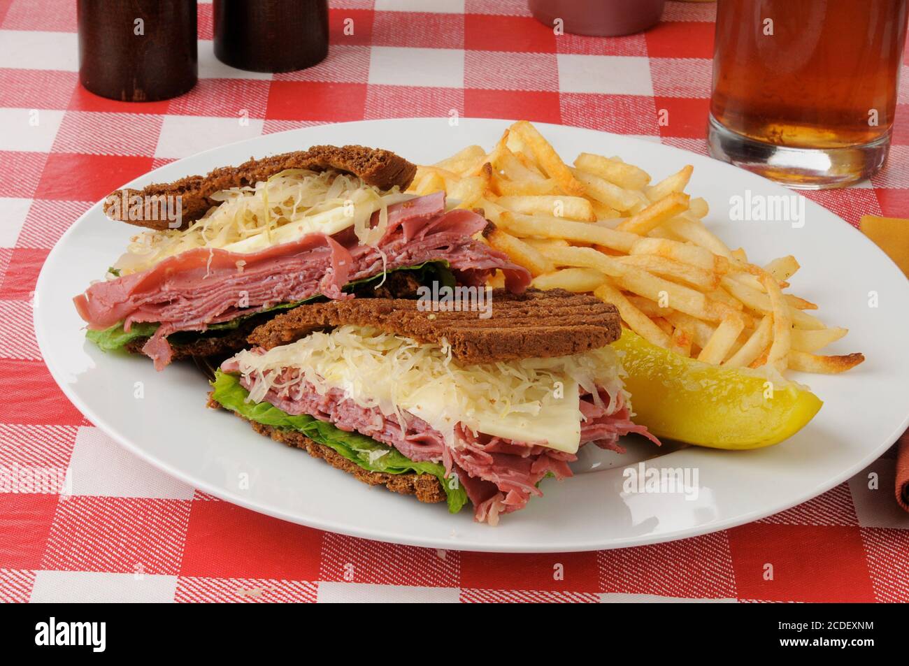 A Reuben sandwich on dark rye with french fries Stock Photo - Alamy