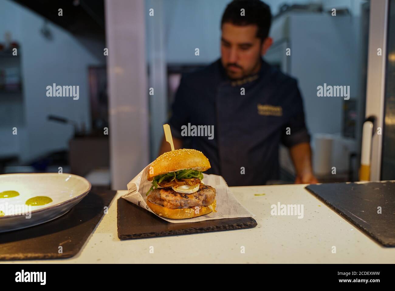 Close-up on the preparation of a magnificent burger in a restaurant ...