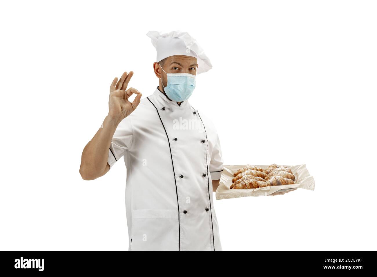 Cooker, chef, baker in face mask in uniform on white background with ...
