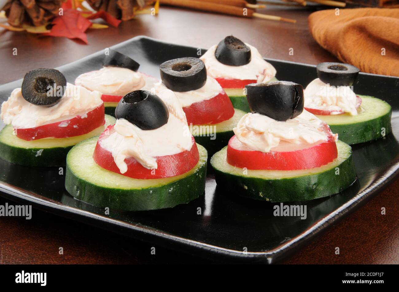 A plate of canapes with cucumber, radish and cream cheese Stock Photo ...