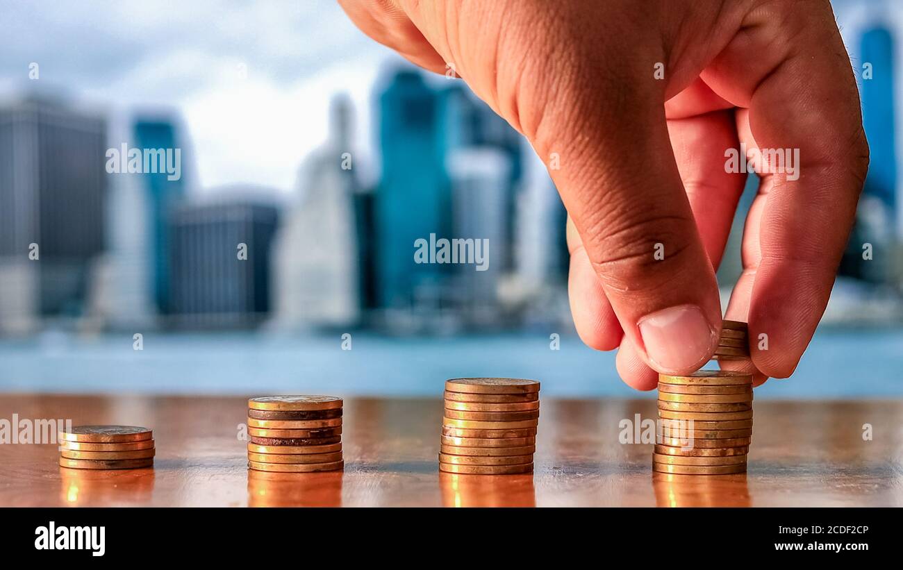 Hand adds money hi-res stock photography and images - Alamy