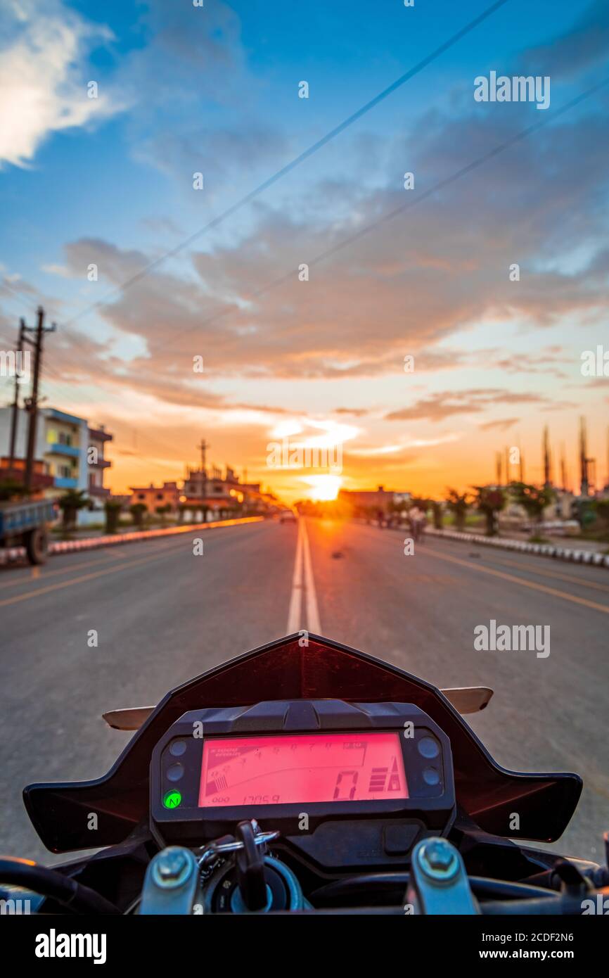 POV Motorbike Speedometer Against The Setting Sun on the Highway Stock ...