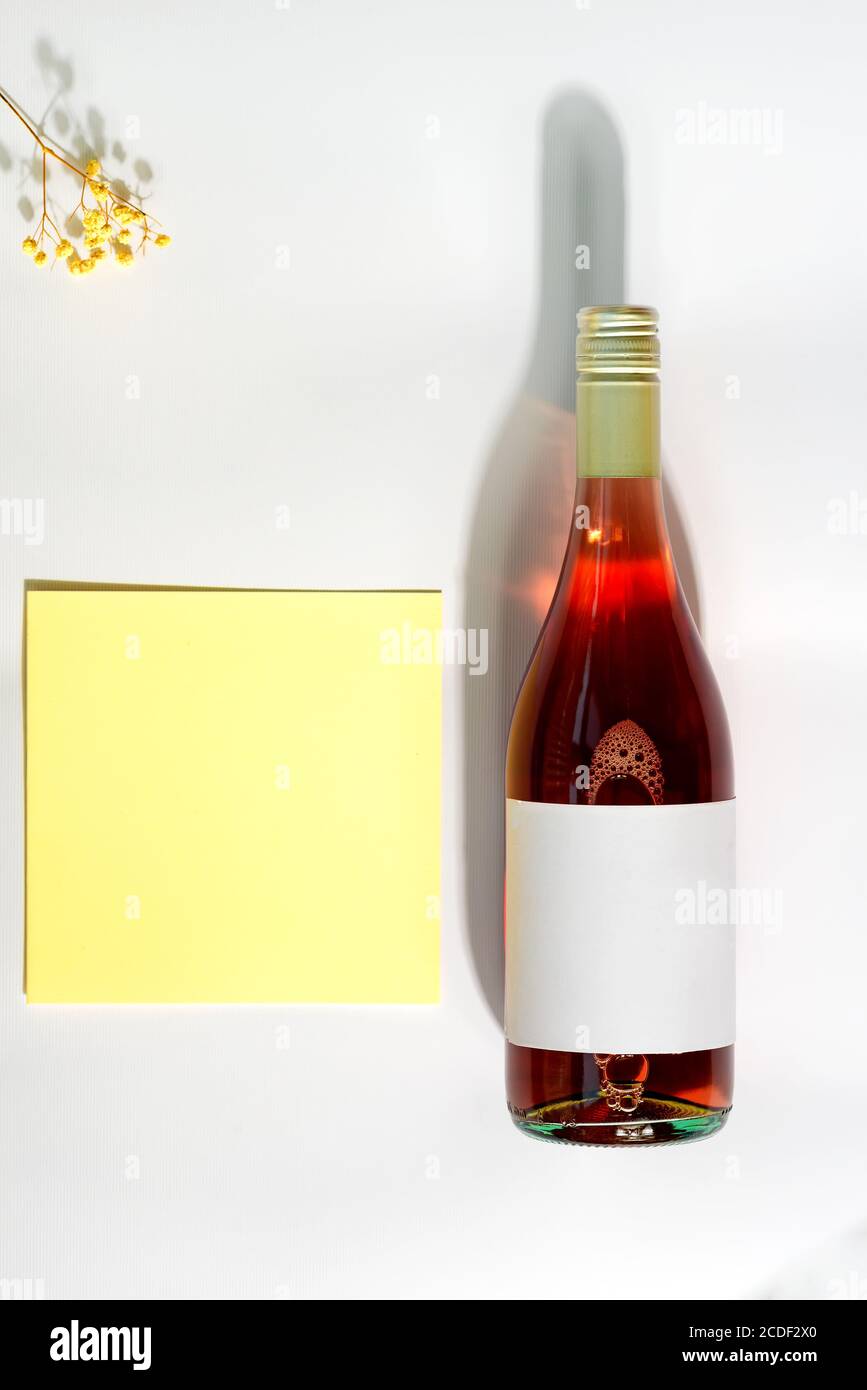 Congratulation postcard with bottle of rose wine, tender natural flower ...