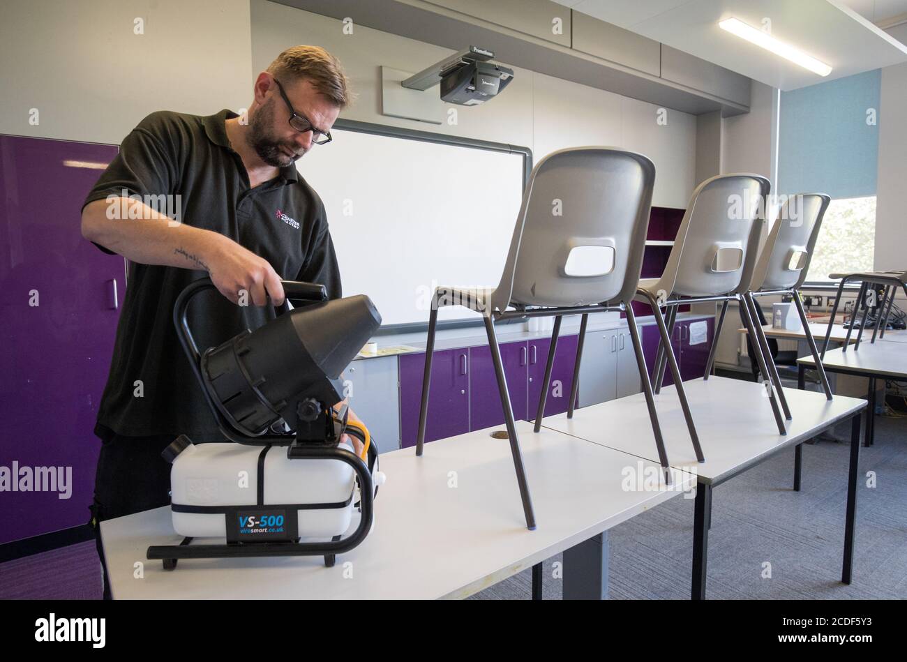 A fogging machine, which can disinfect a whole classroom, is set up in ...