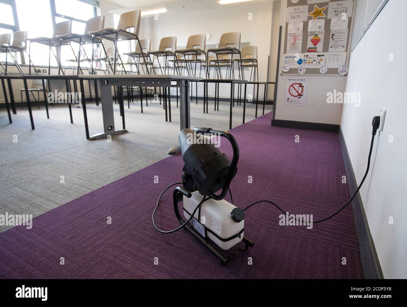A fogging machine, which can disinfect a whole classroom, is set up in ...