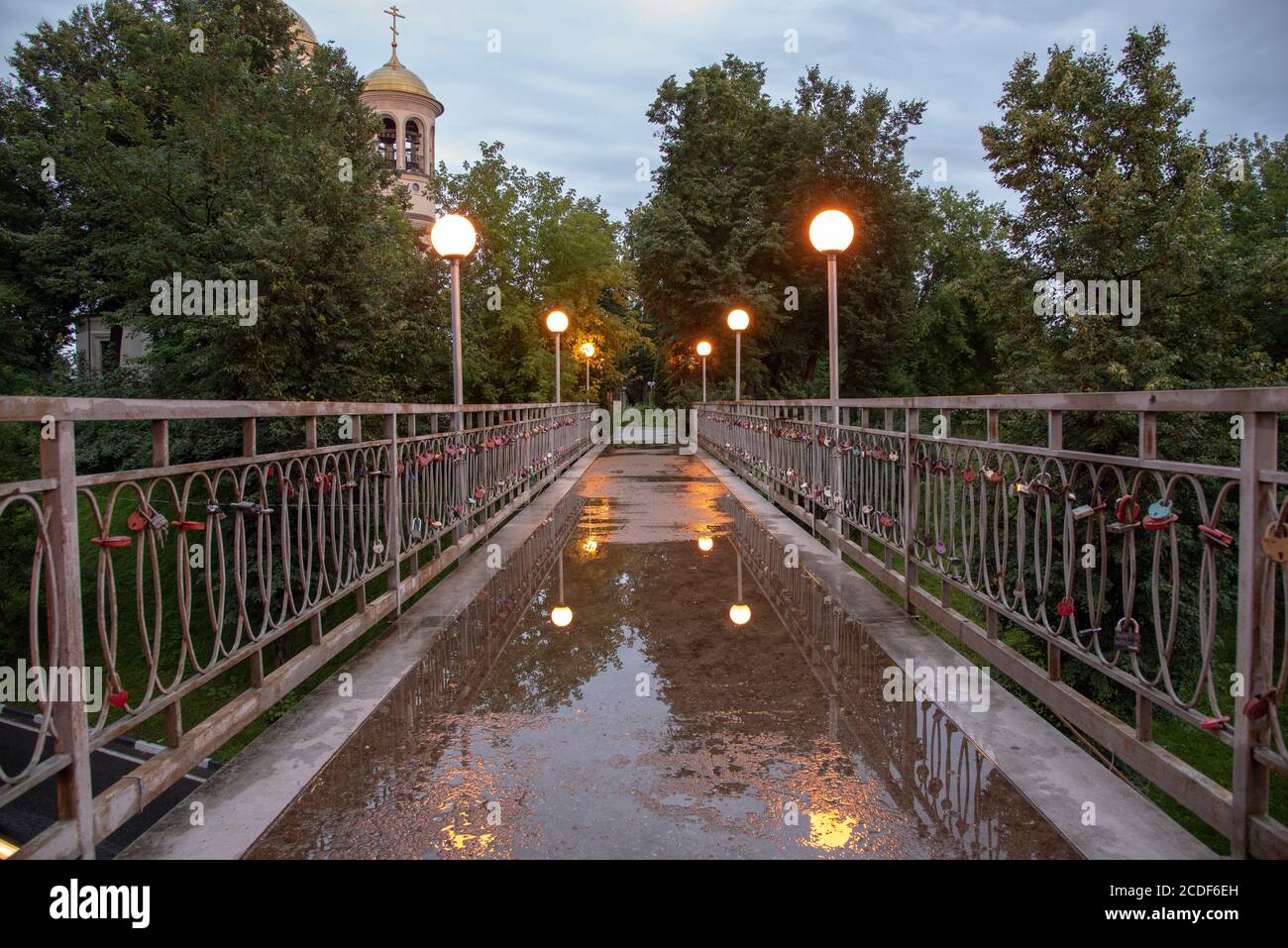A small pedestrian bridge illuminated by lanterns Stock Photo - Alamy