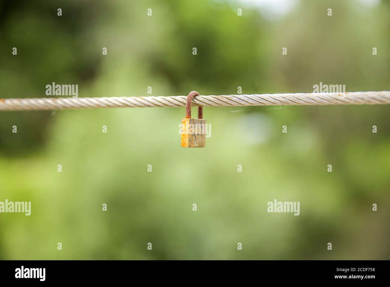 Padlock hanging on a rope Stock Photo - Alamy