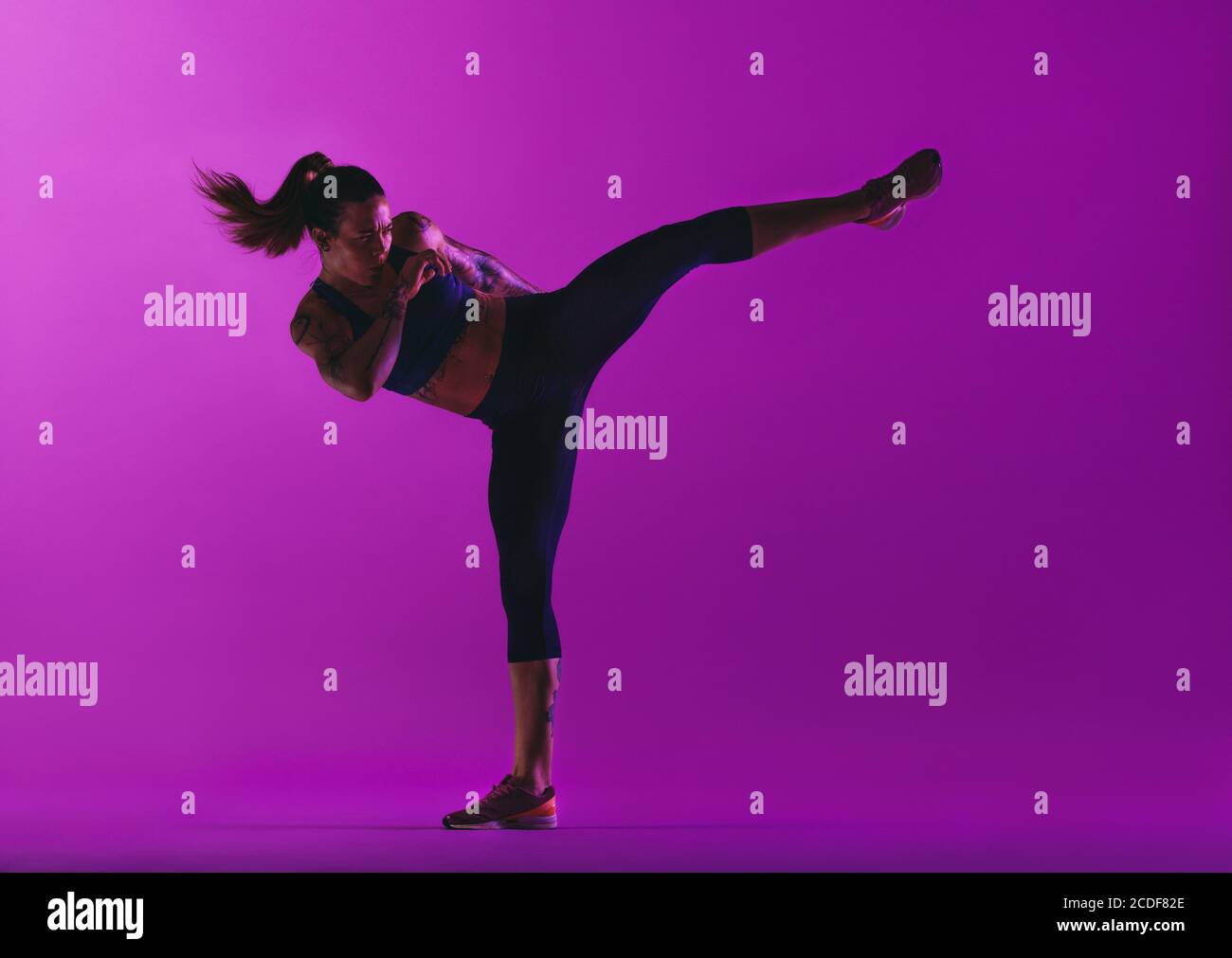 Female athlete doing fitness workout. Muscular woman balancing on one ...