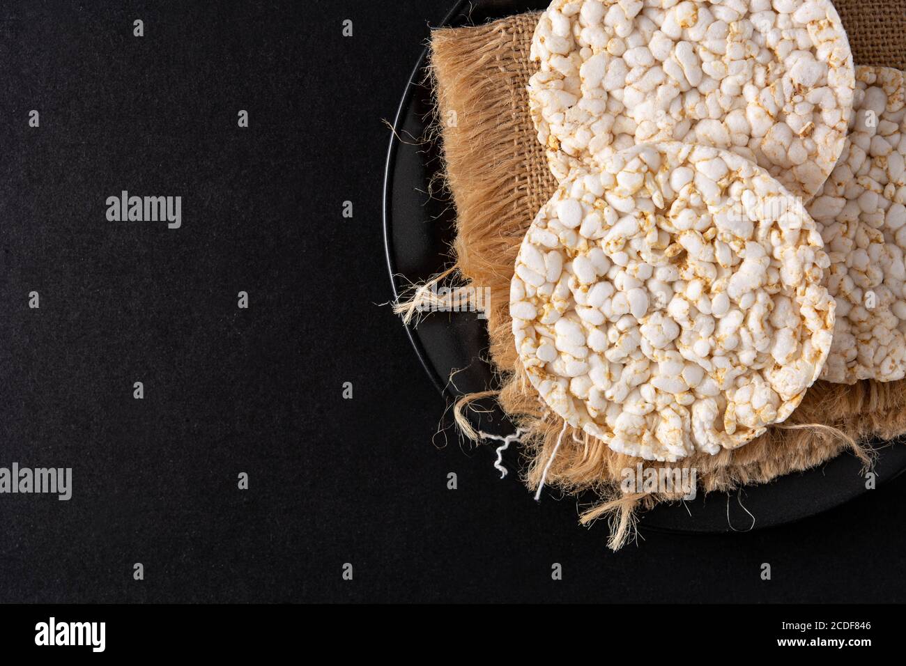 Puffed rice cakes on black background Stock Photo - Alamy