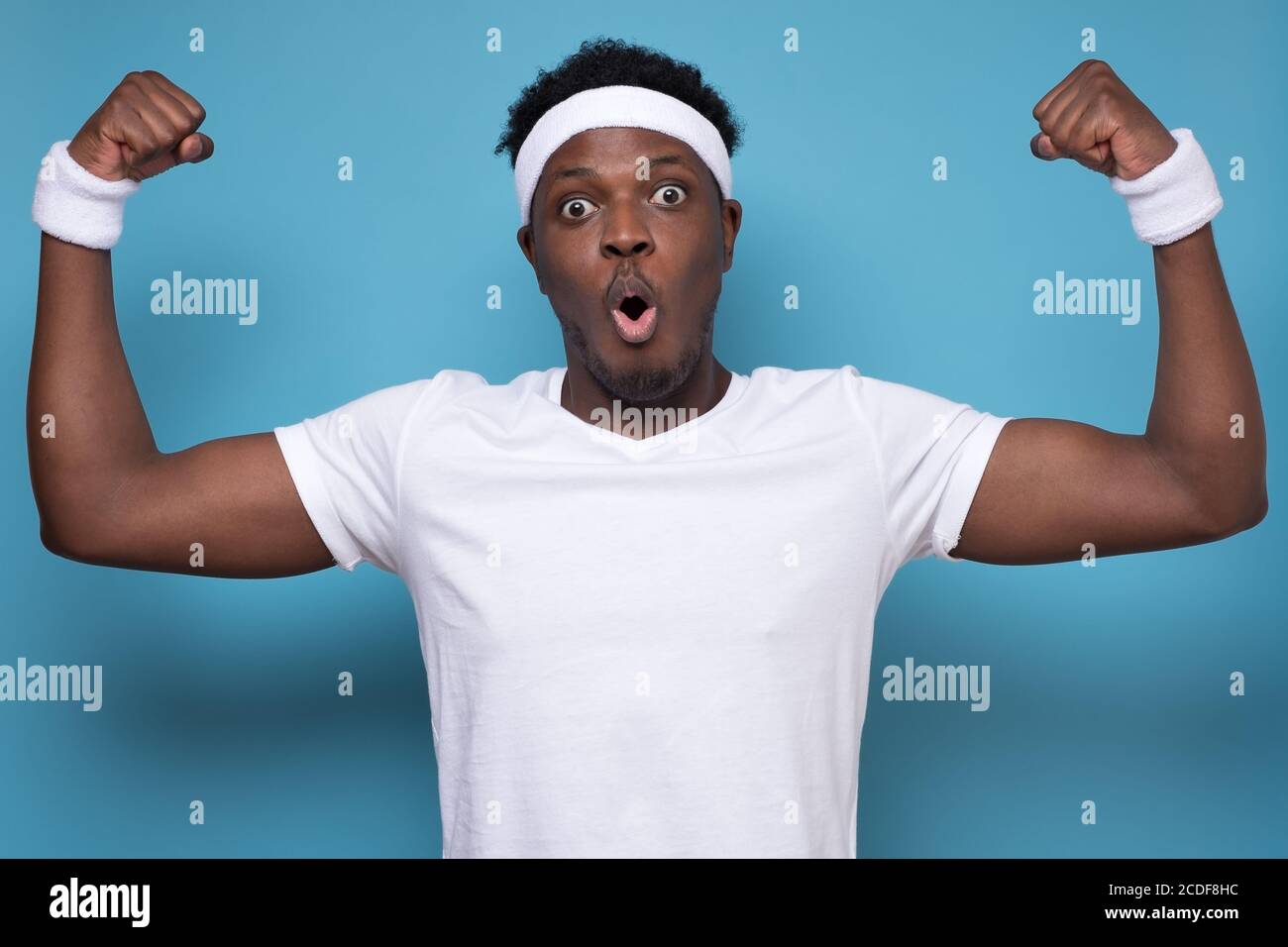african man feeling strong raising fist up, showing his muscles Stock ...