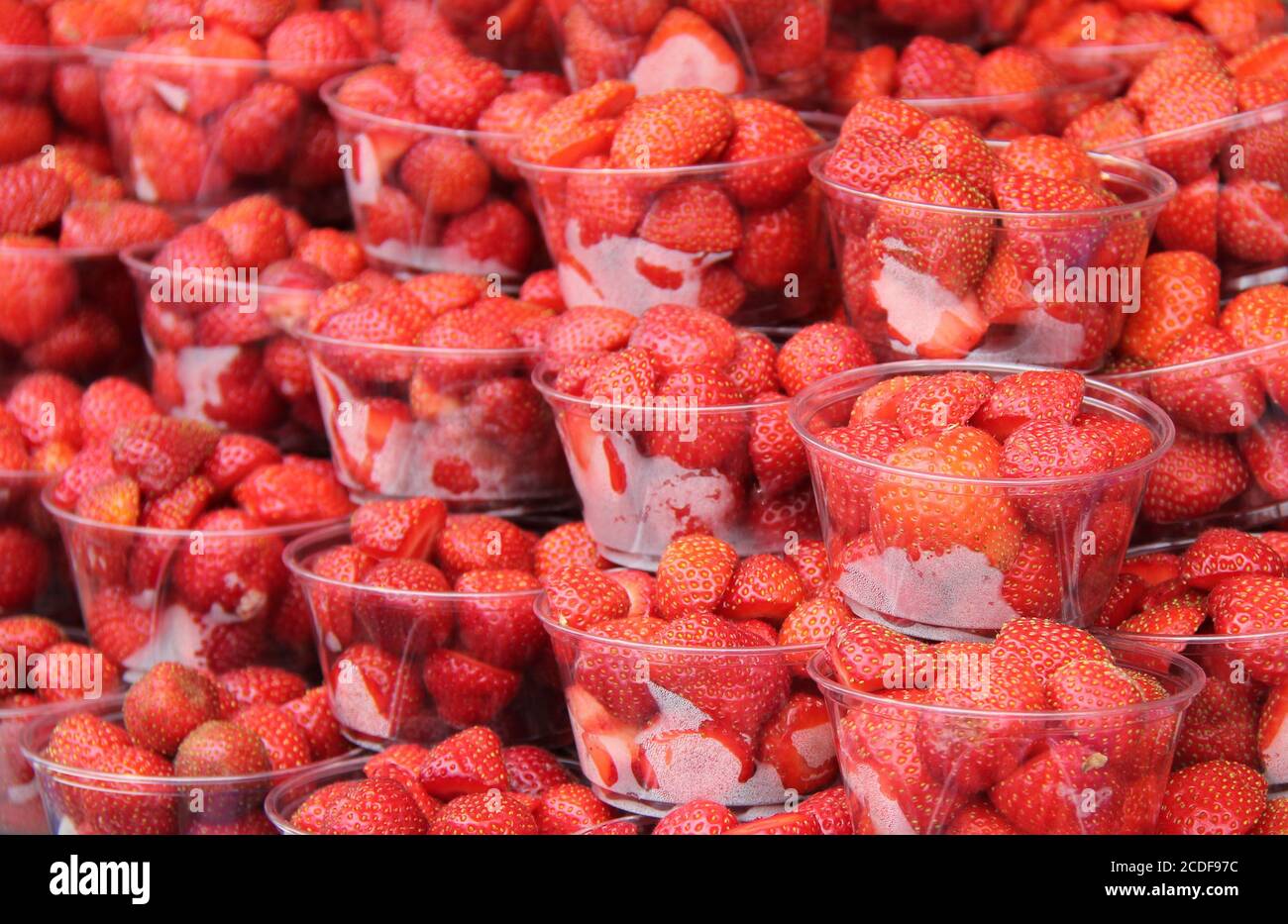 A Display of Plastic Bowls With Fresh Fruit Strawberries Stock Photo ...