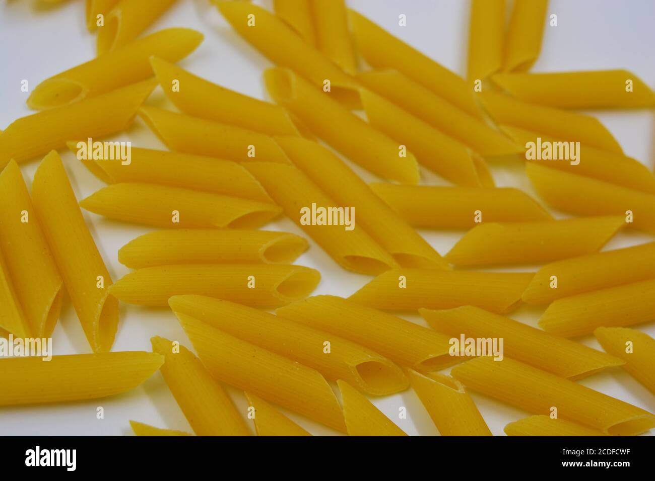 Italian yellow pasta, noodles pasta, durum wheat feathers scattered ...