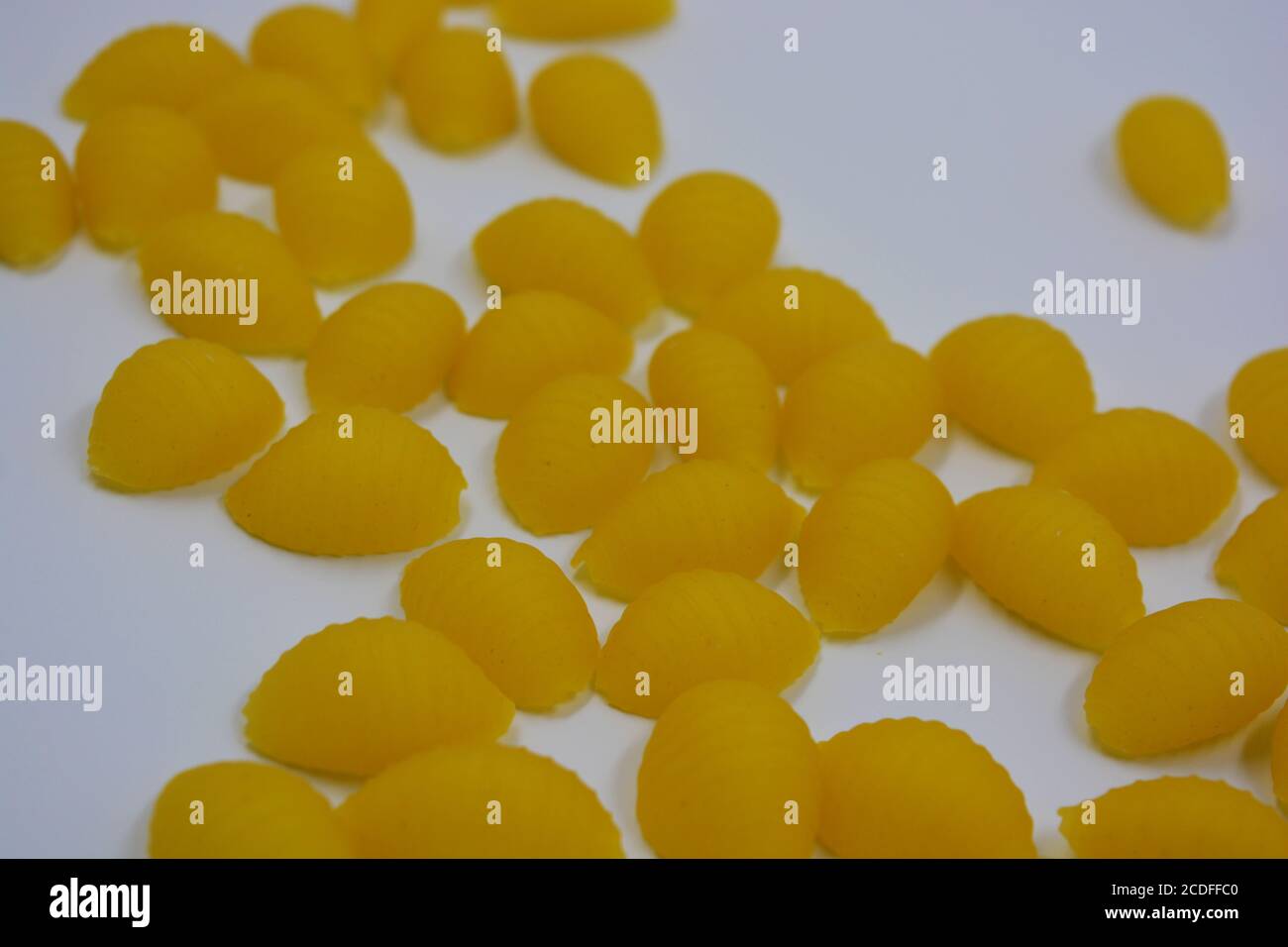 Italian yellow pasta made from durum wheat, vermicelli shells scattered ...