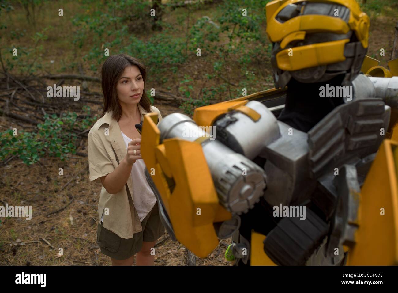 Cosplayer in image of a robot transformer and girl stand together among ...