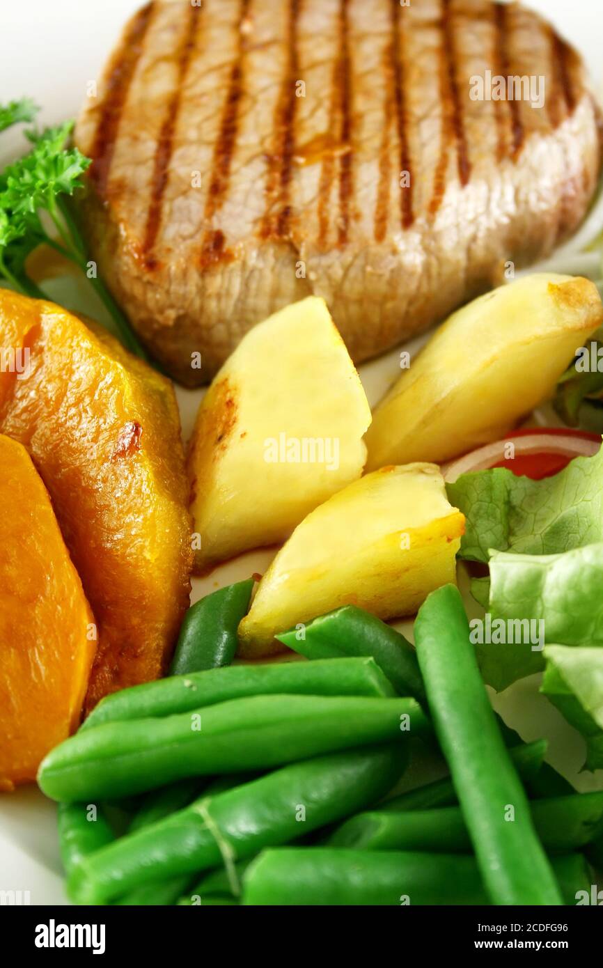 Baked Vegetables And Steak Stock Photo - Alamy