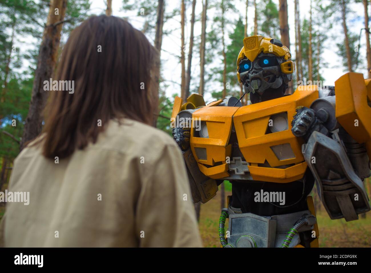 Cosplayer in image of a robot transformer and girl stand together among ...