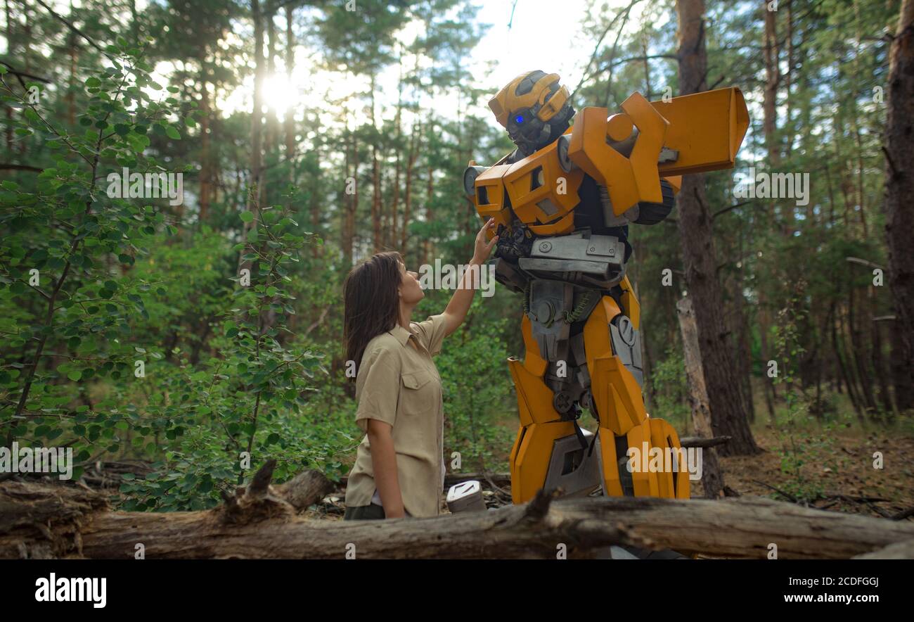 Cosplayer in image of a robot transformer and girl stand together among ...