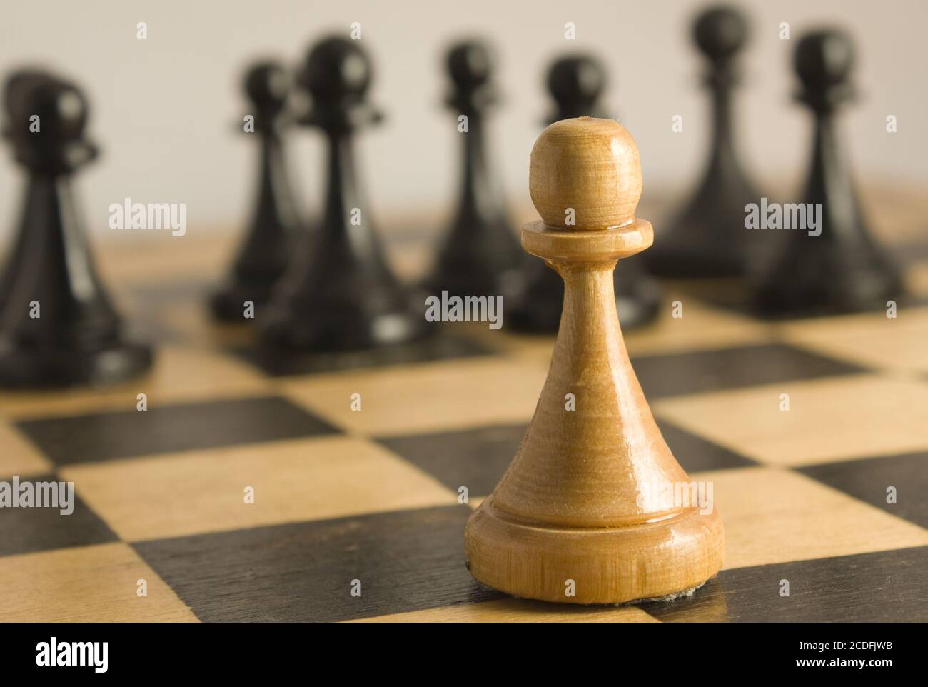 The white pawn resists to black pawns and is on crossing of squares ...