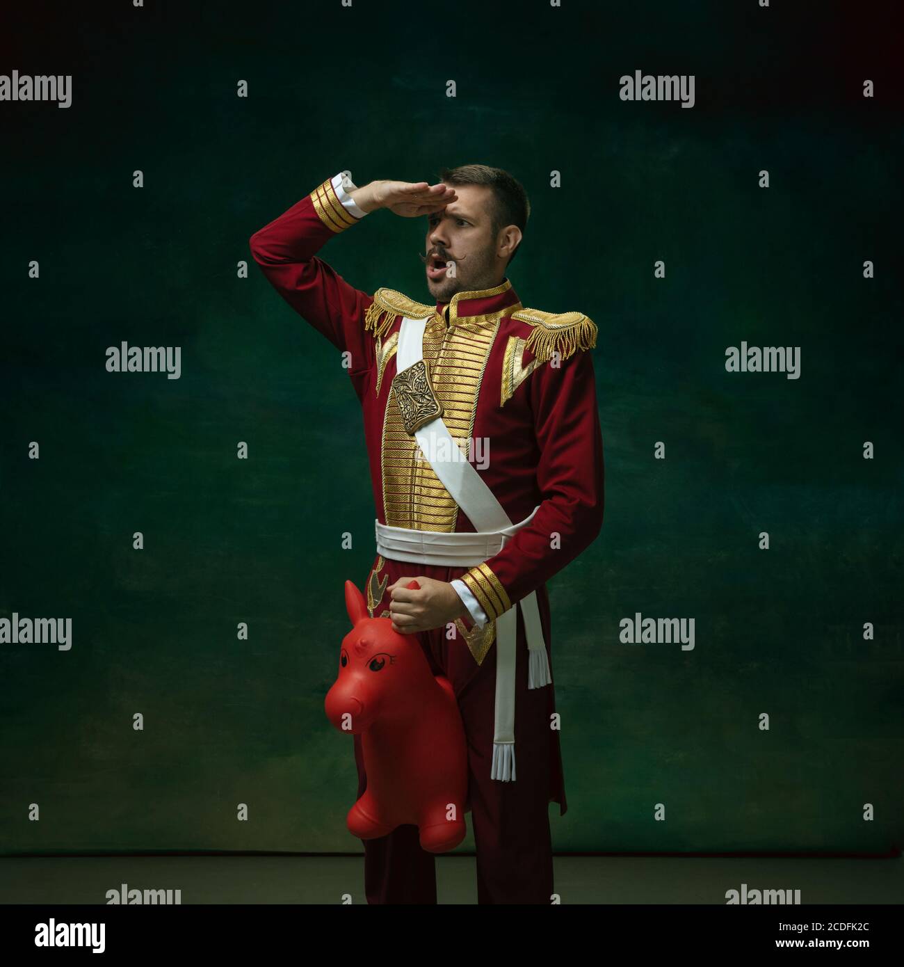 Looking for army. Young man in suit as Nicholas II isolated on dark ...