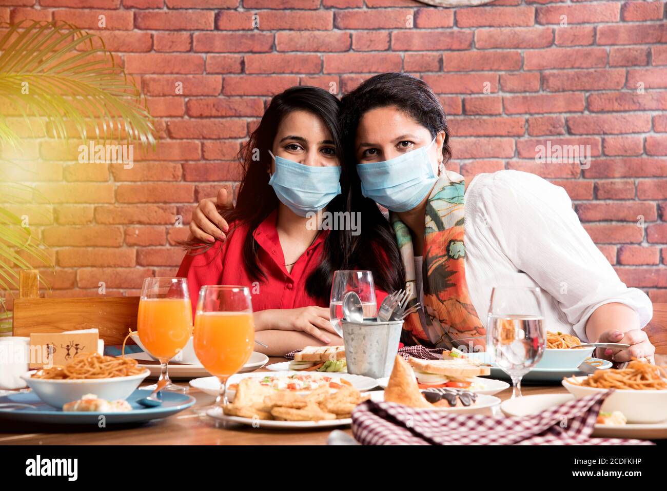 Happy indian family at restaurant hi-res stock photography and images ...