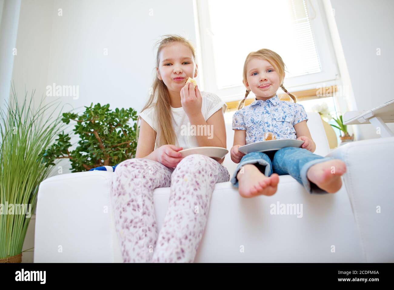Two children eat a fresh cake together for their birthday Stock Photo ...
