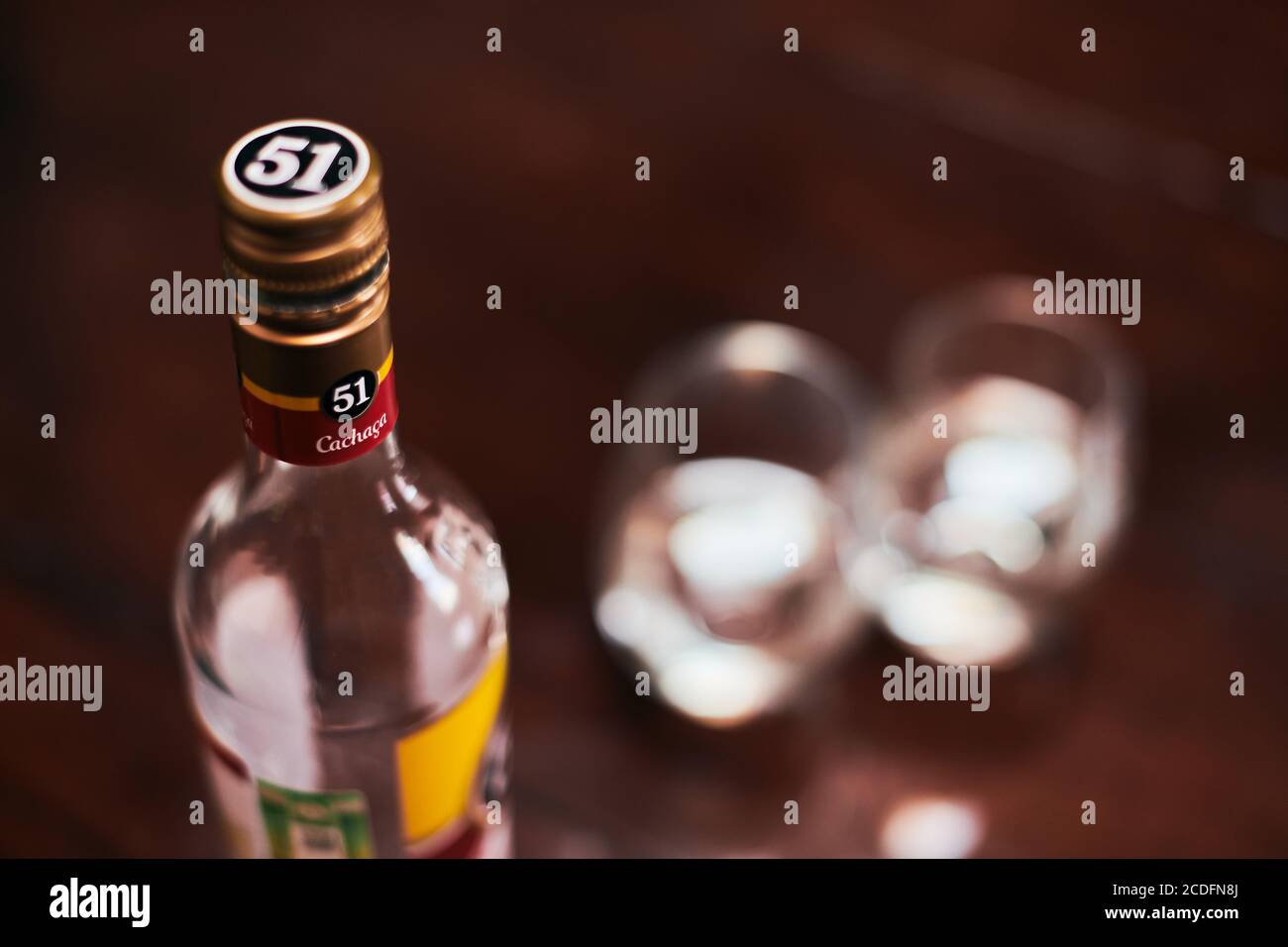 Moscow - 23.11.2019 - Cachaca 51 bottle with two glasses. Brazilian rum ...