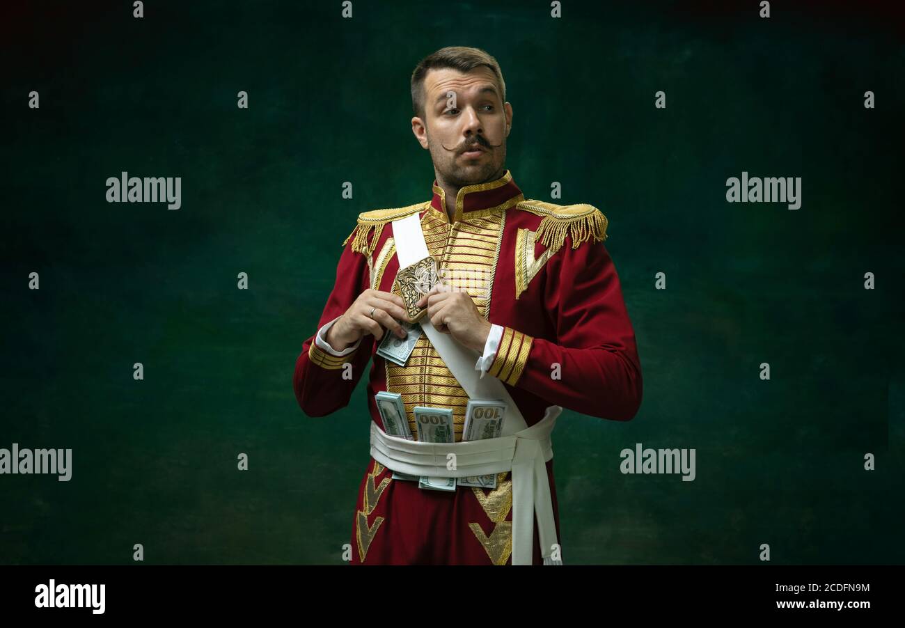 Rich for sale. Young man in suit as Nicholas II isolated on dark green ...