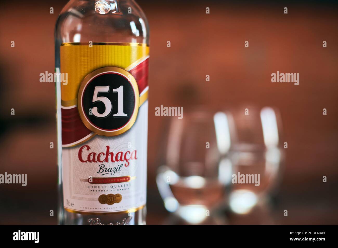 Moscow - 23.11.2019 - Cachaca 51 bottle with two glasses. Brazilian rum ...