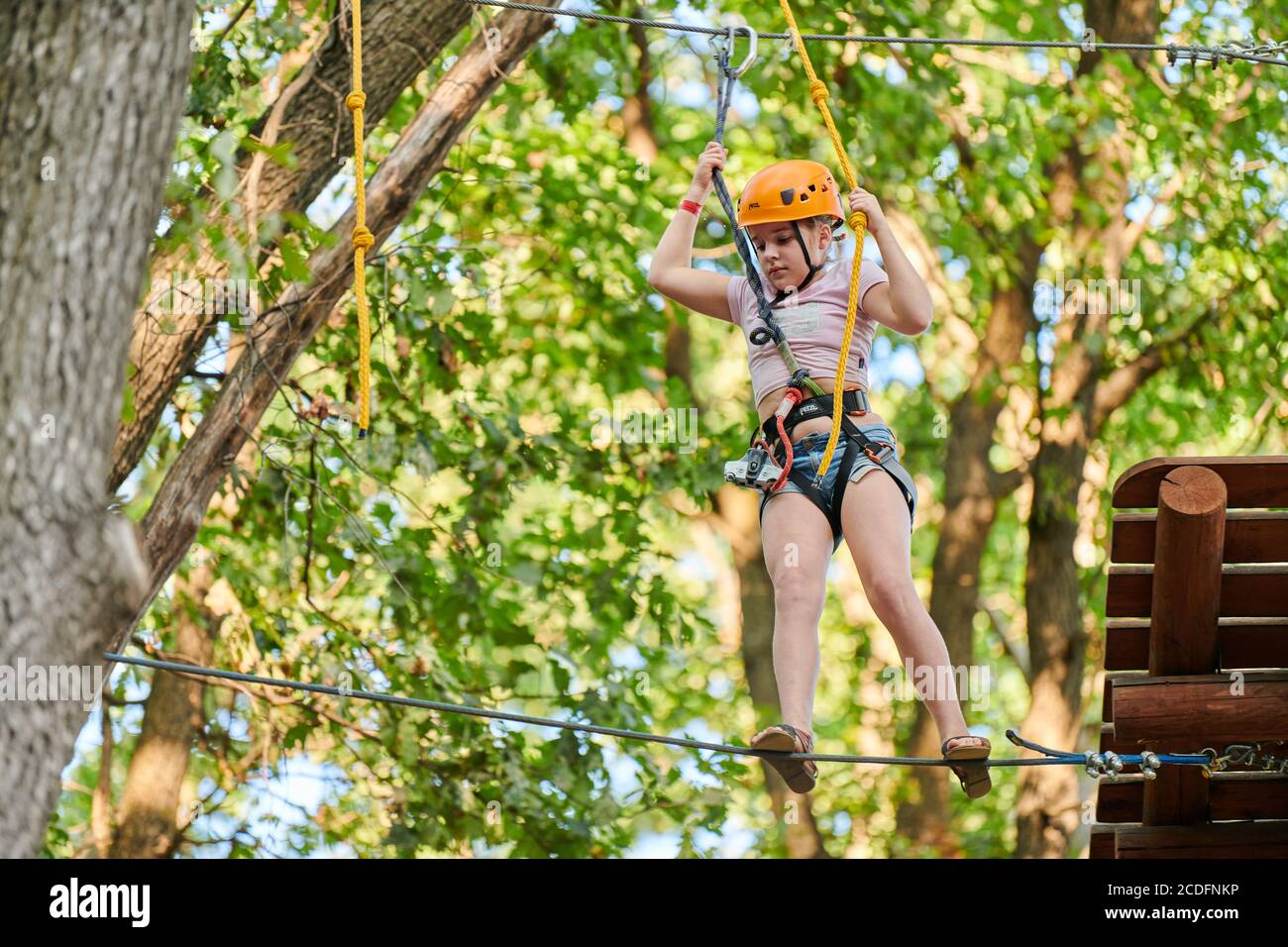 Girl in high ropes experience adventure tree park. Rope road course in ...