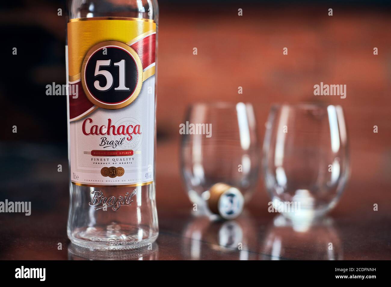 Moscow - 23.11.2019 - Cachaca 51 bottle with two glasses. Brazilian rum ...
