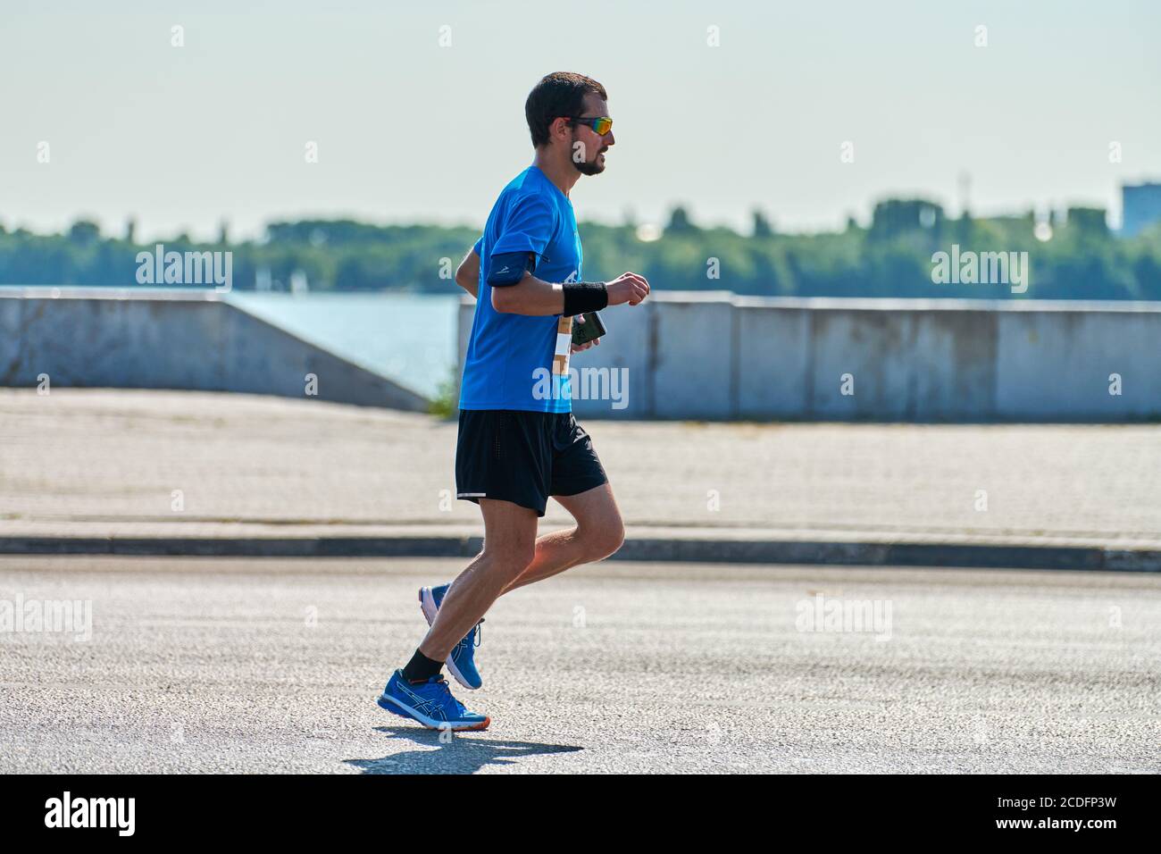 Voronezh, Russia - 24.08.2019 - Young man runs along road. Runners ...