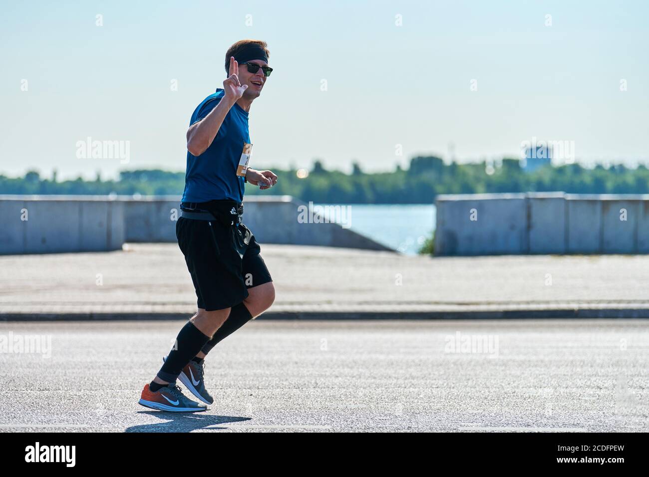 Voronezh, Russia - 24.08.2019 - Young man runs along road. Runners ...