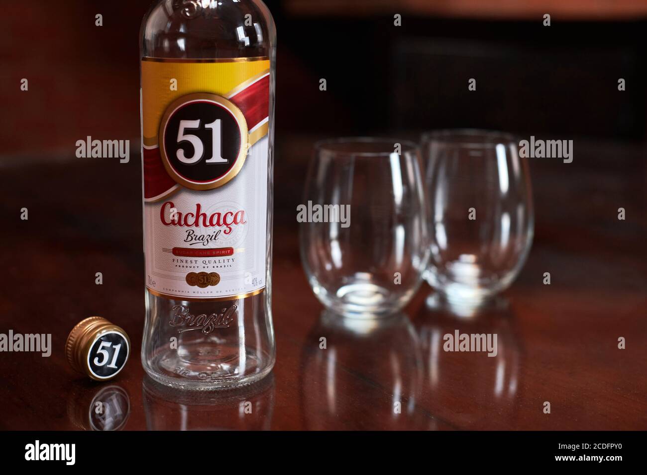 Moscow - 23.11.2019 - Cachaca 51 bottle with two glasses. Brazilian rum ...