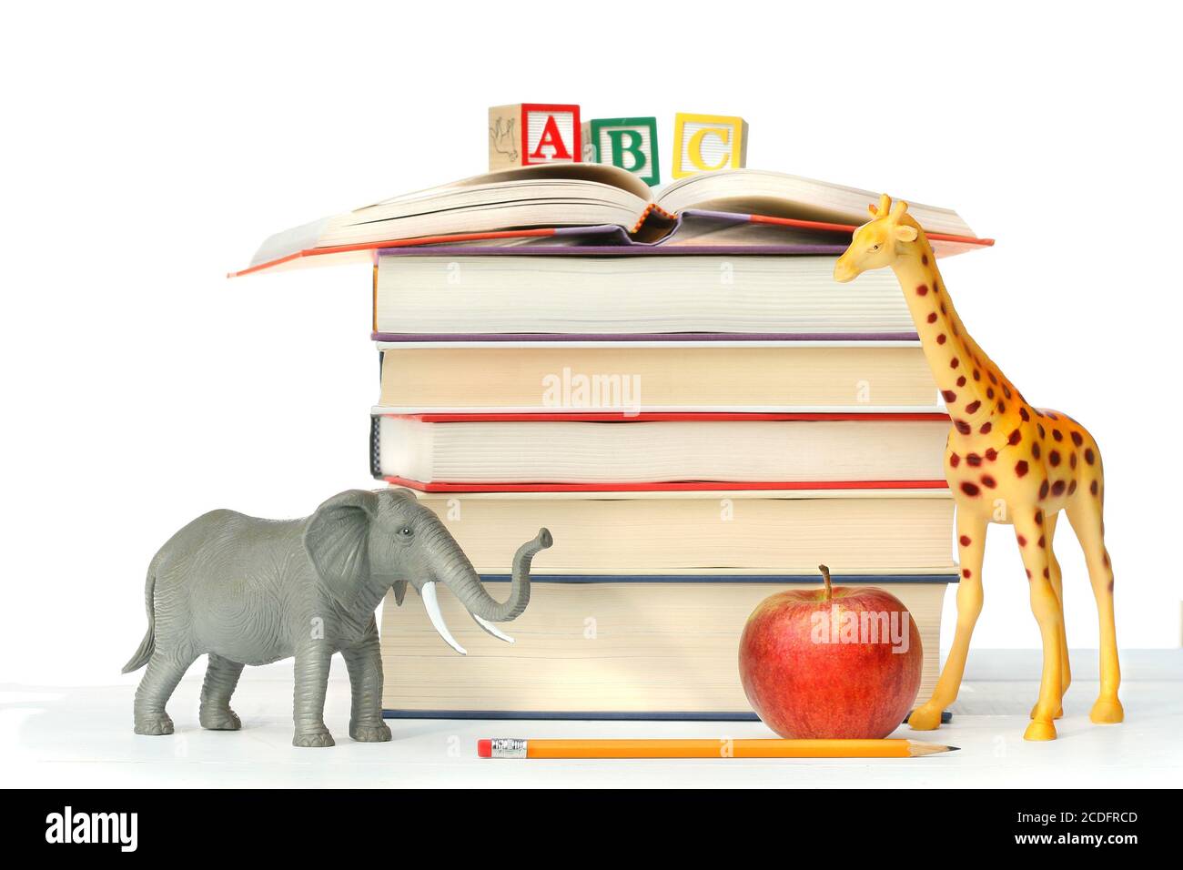 Stack of books with toy animals Stock Photo - Alamy