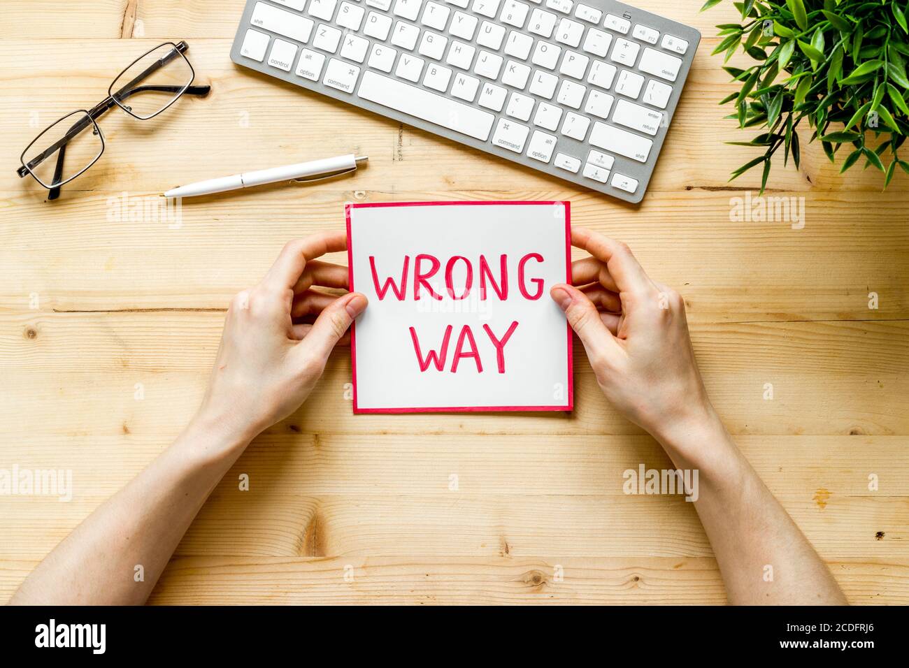 Business failure. Wrong way icon in hands on office desk top-down Stock ...