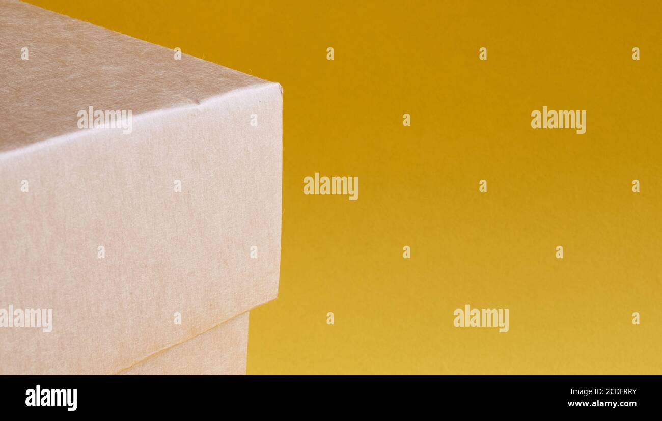 Corner of a brown cardboard box close up on a yellow background Stock ...