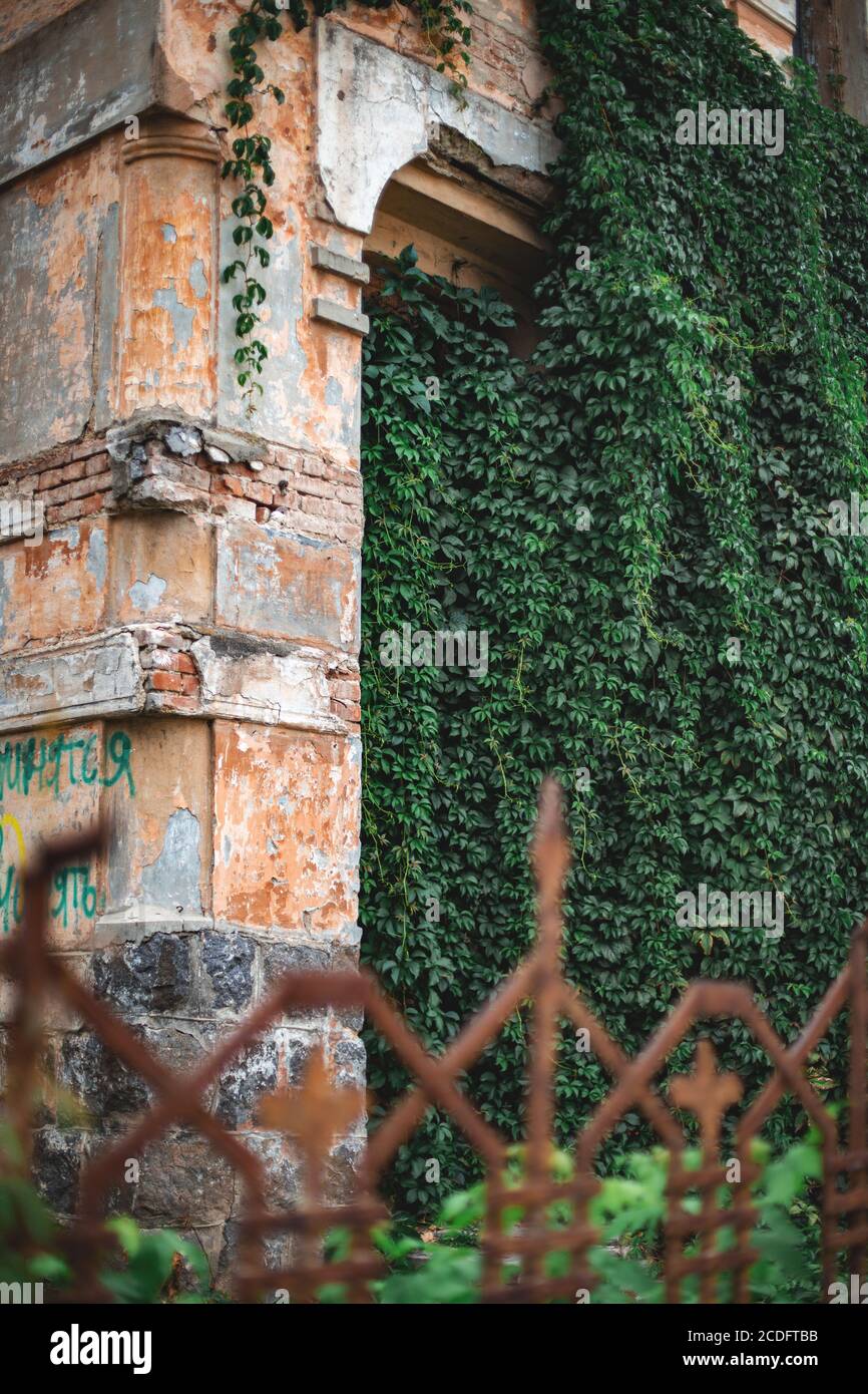 Vertical shot of the facade of an old, abandoned brick building ...