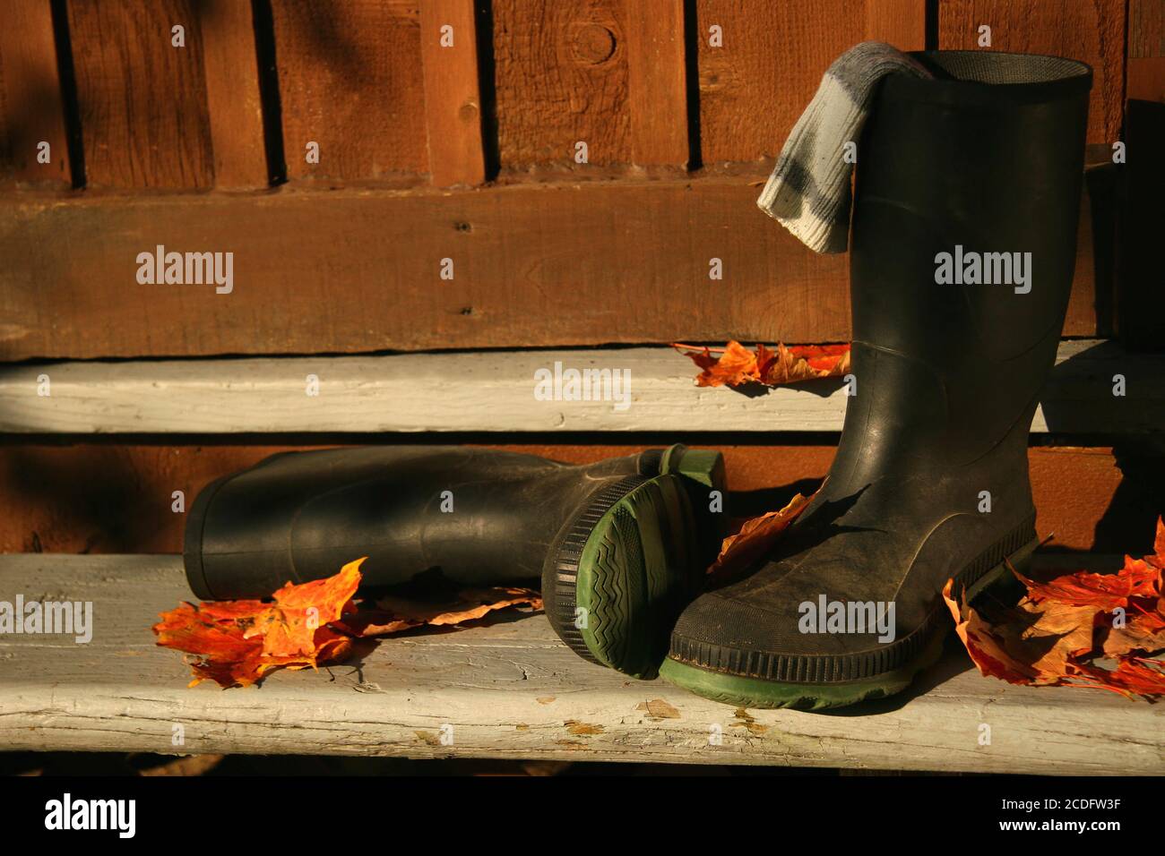Rubber boots laying on porch steps Stock Photo - Alamy