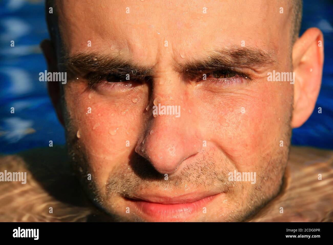 Handsome man gazing while in water Stock Photo - Alamy