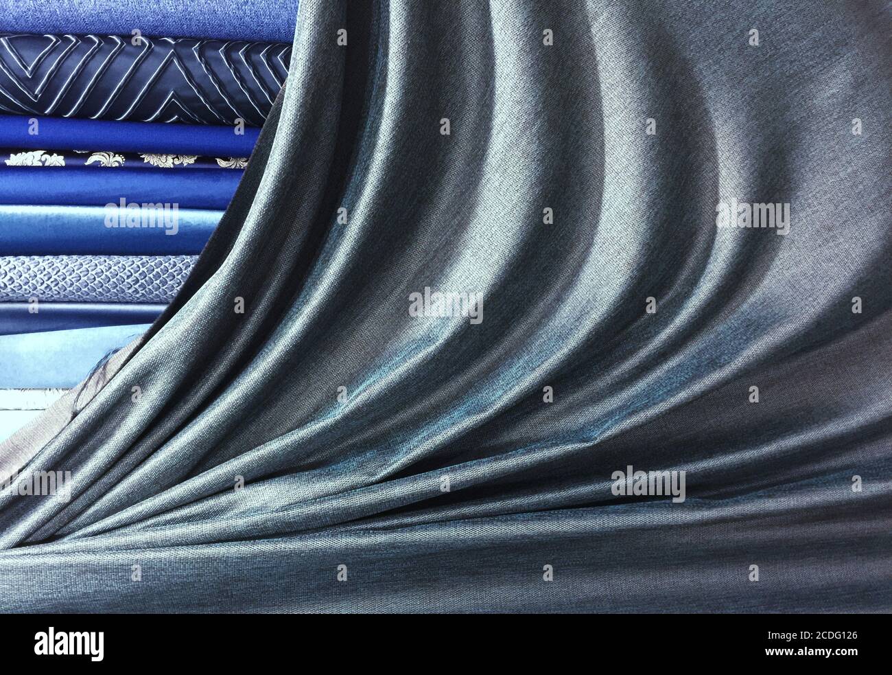 Silk silver curtain. Rolls of various fabrics. Background texture Stock ...