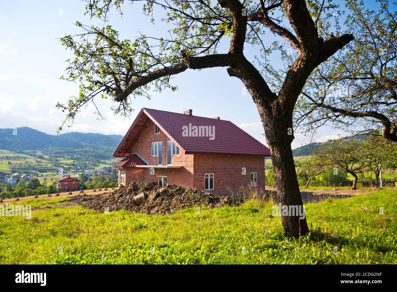Apple tree and new house Stock Photo - Alamy