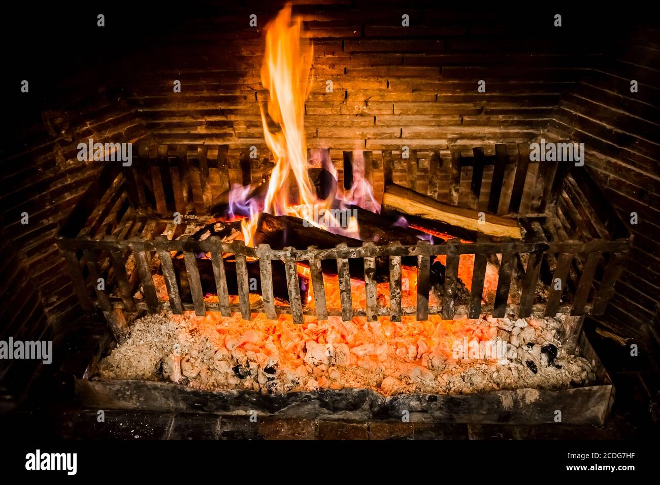 Burning logs in a Winter fireplace Stock Photo - Alamy