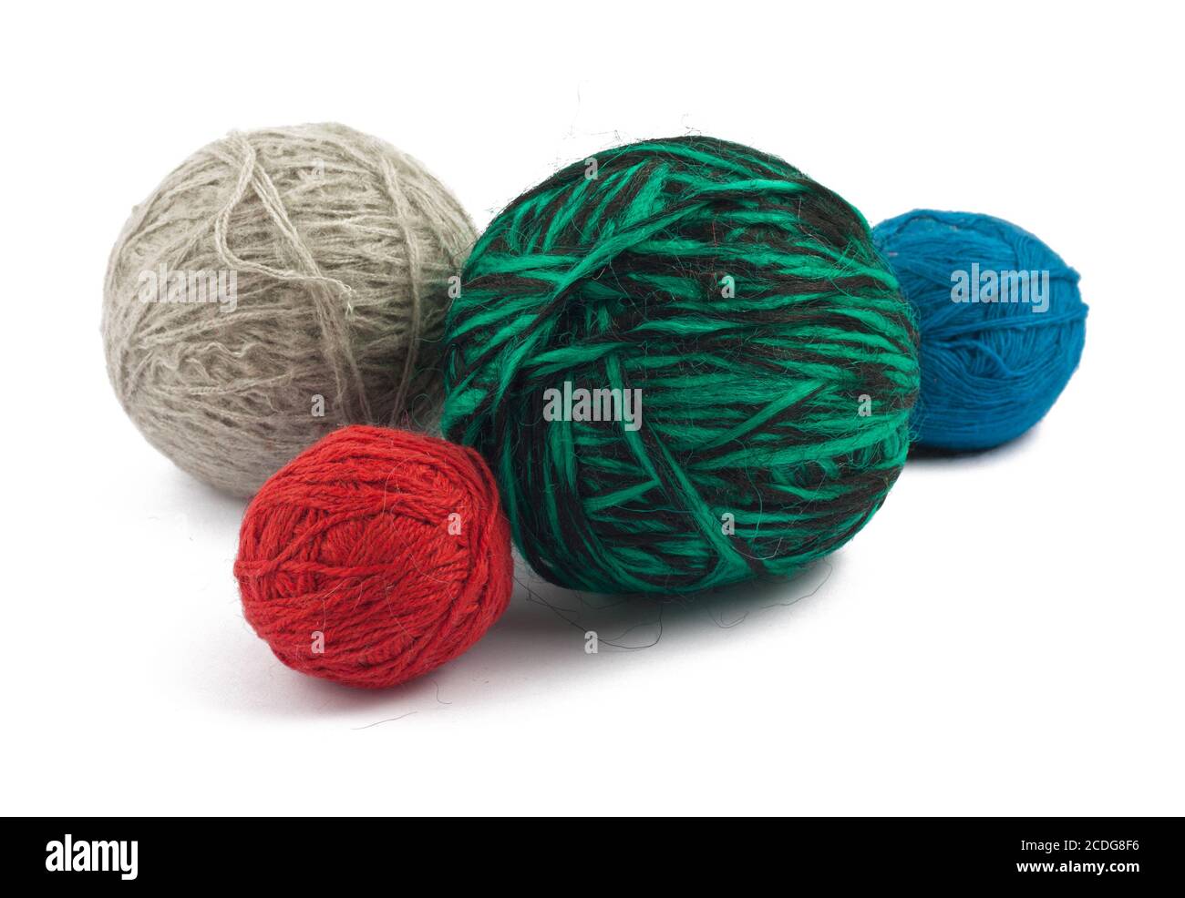 Four balls of wool on white background Stock Photo - Alamy
