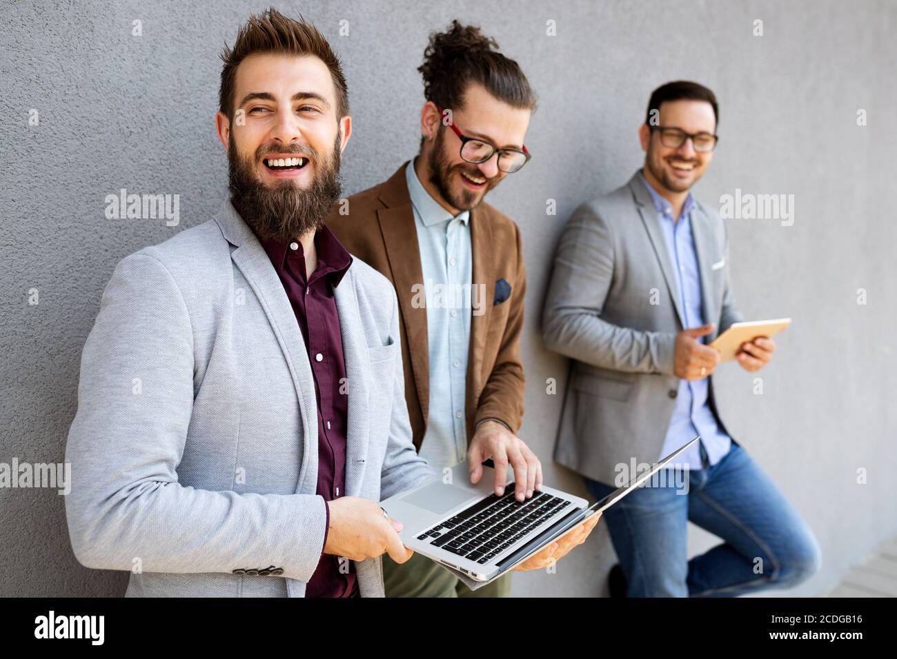 Cheerful happy businessmen using laptop at the meeting outdoor Stock ...