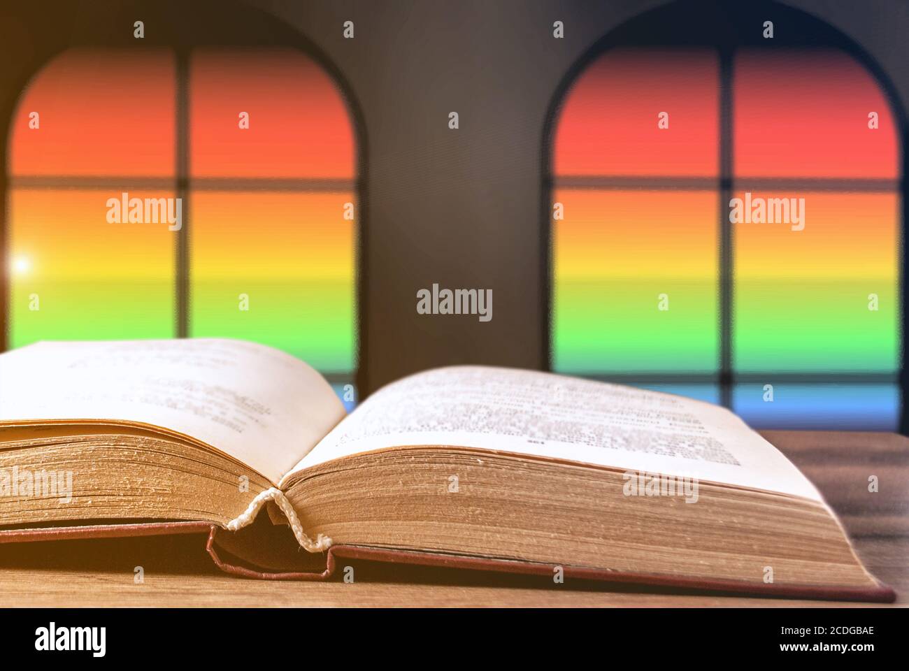 An open book on the table, against the background of windows. Gothic ...