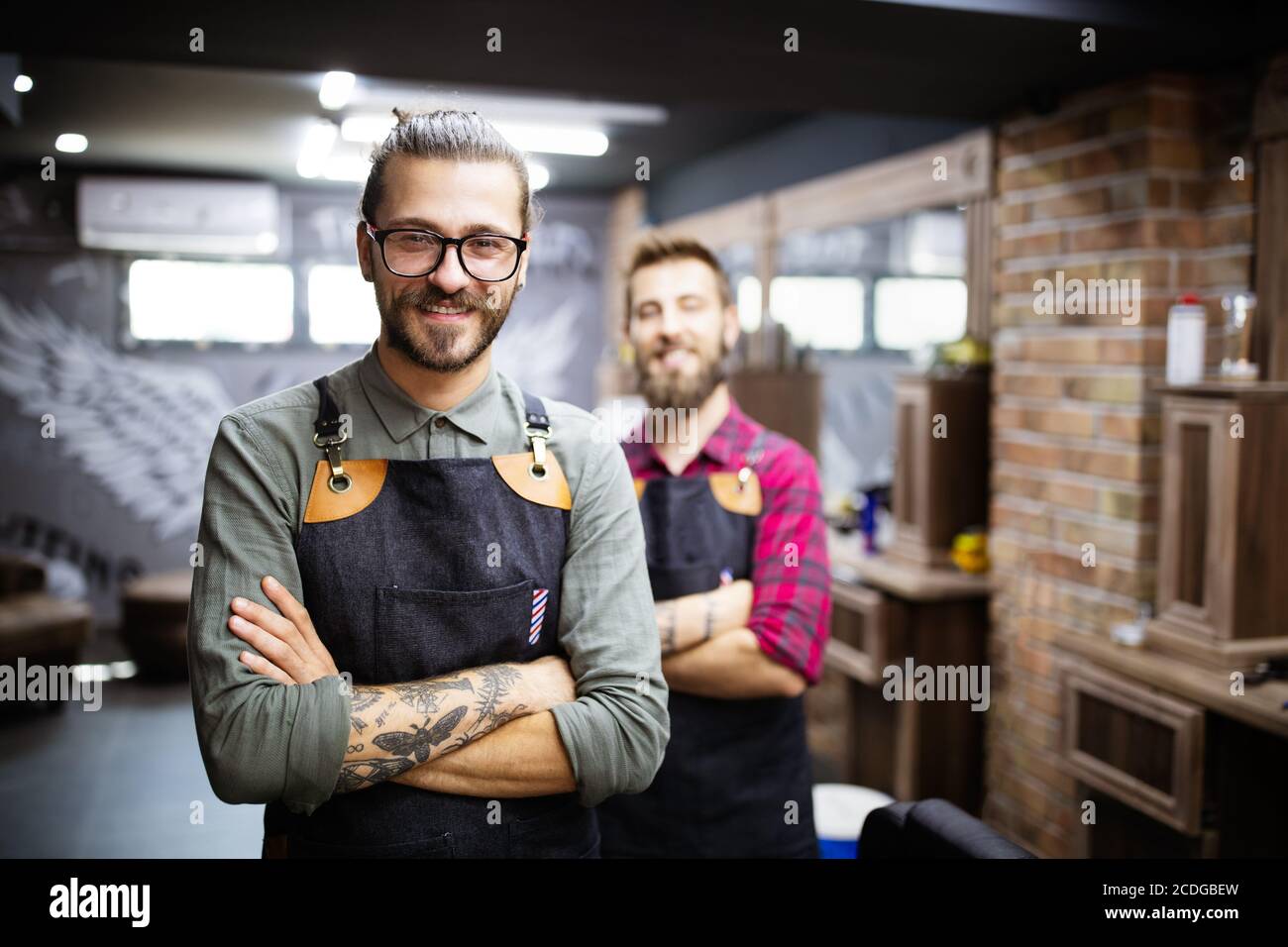Portrait of young male barbers and hairdressers in barber shop Stock ...