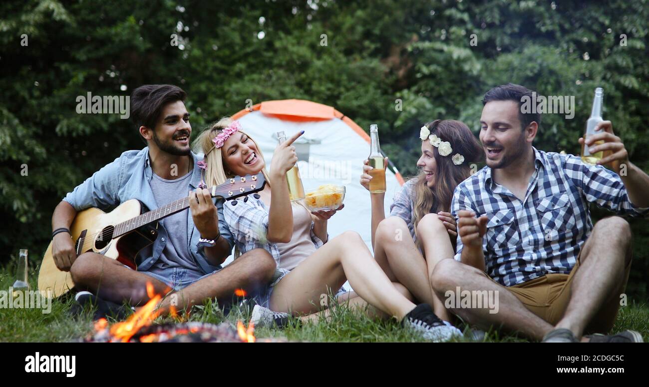 Friends having bonfire party anf fun together Stock Photo - Alamy